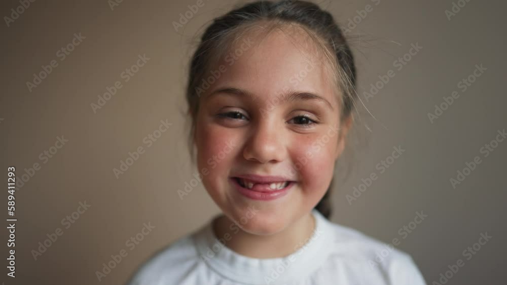 Close-up of face of cute, harmless girl. happy child without milk teeth ...