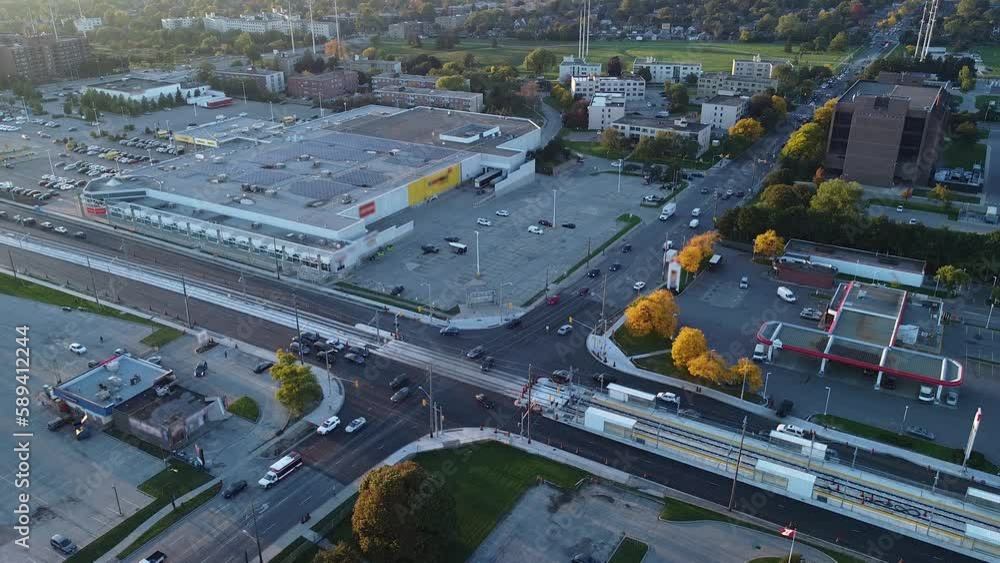 Light Rail Transit (LRT) crossing major city intersection with cars and ...