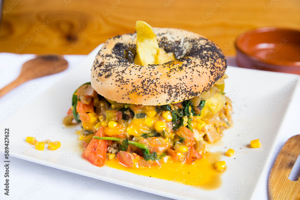 Delicious vegan sandwich on bagel bread. A bagel is a bread ...