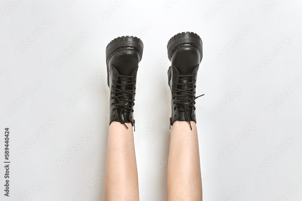 Woman legs in black combat boots on high heel platform with lug soles ...