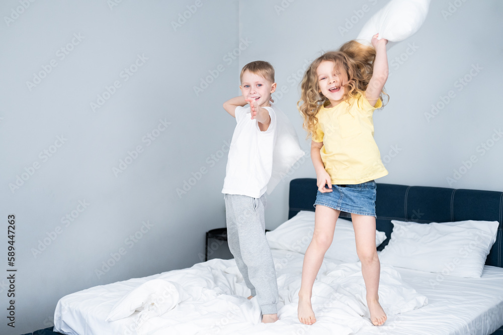 Boy and girl playing in parents bed. family morning. Small children ...