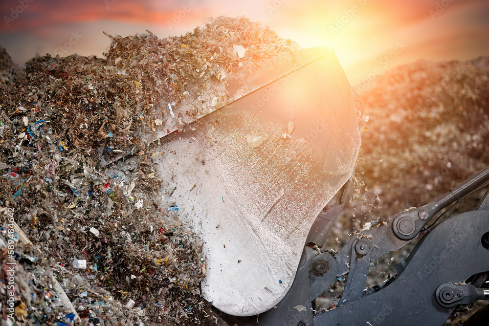 Huge bucket of heavy loader processing pile of refuse-derived fuel (RDF ...