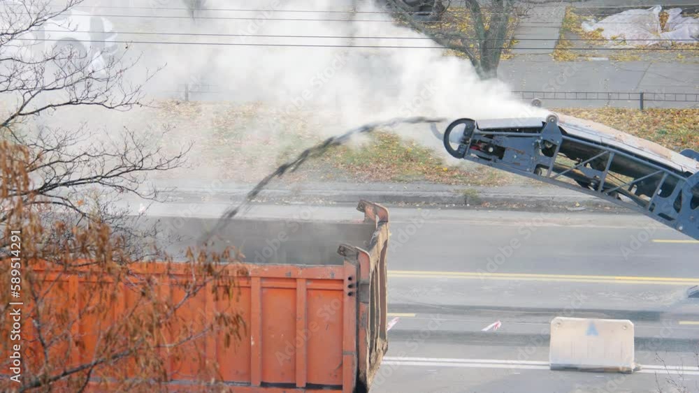 Road milling machine removes old asphalt. Hot smoking finely crushed ...