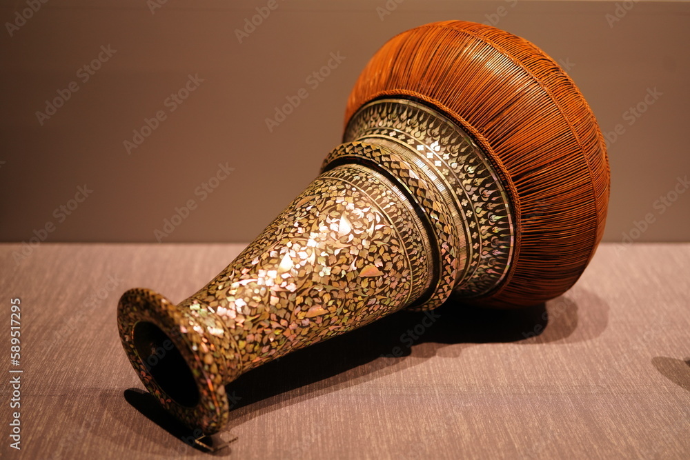 A water bottle carved with mother of pearl shells is displayed in the ...