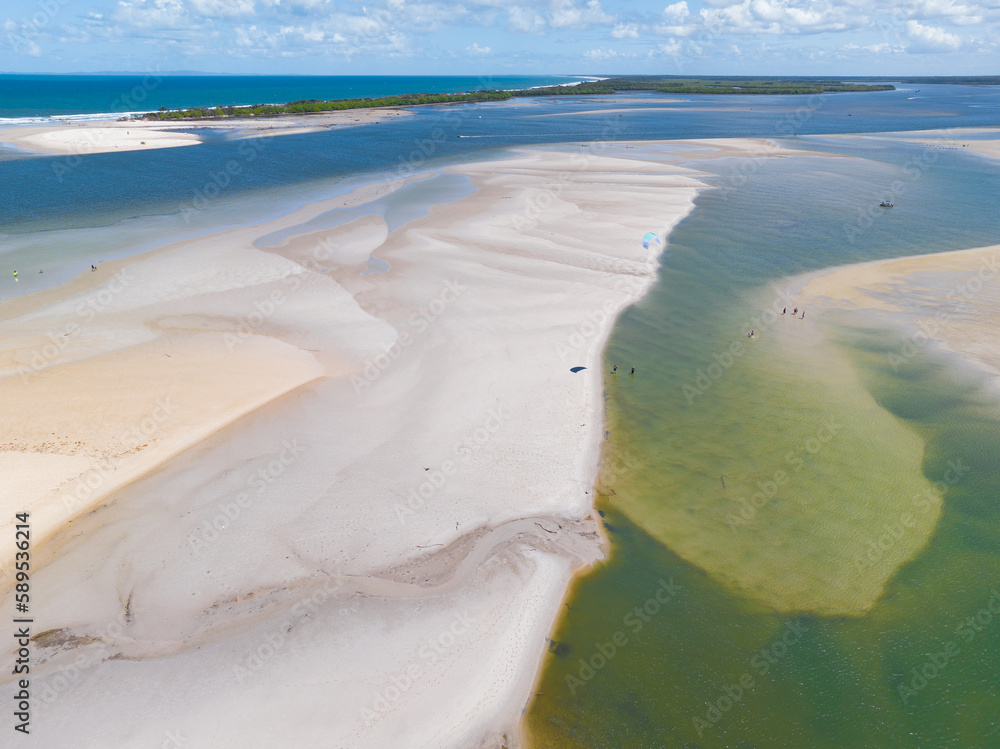 Aerial view of white sand bars around in a river mouth near blue sea ...