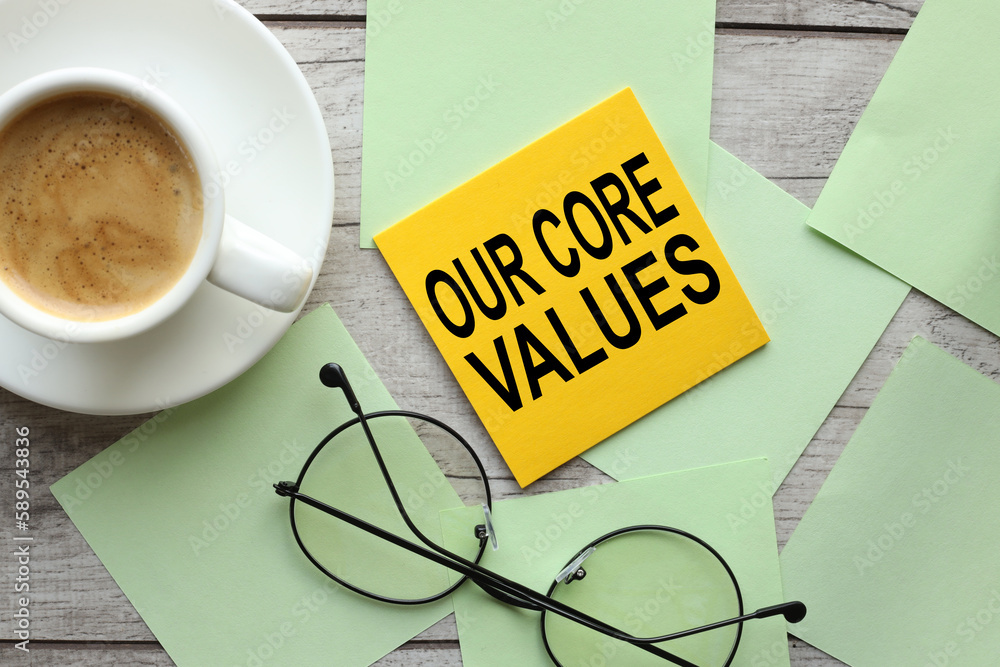 colored note paper with text Our core values symbol pinned to wood ...