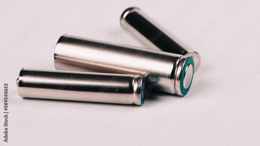 Three silver AA and AAA batteries isolated on white. Side view. Loop ...