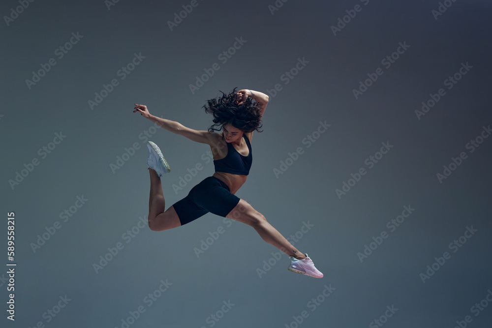 In motion. Art of movement. Attractive young woman with slim, fit body ...