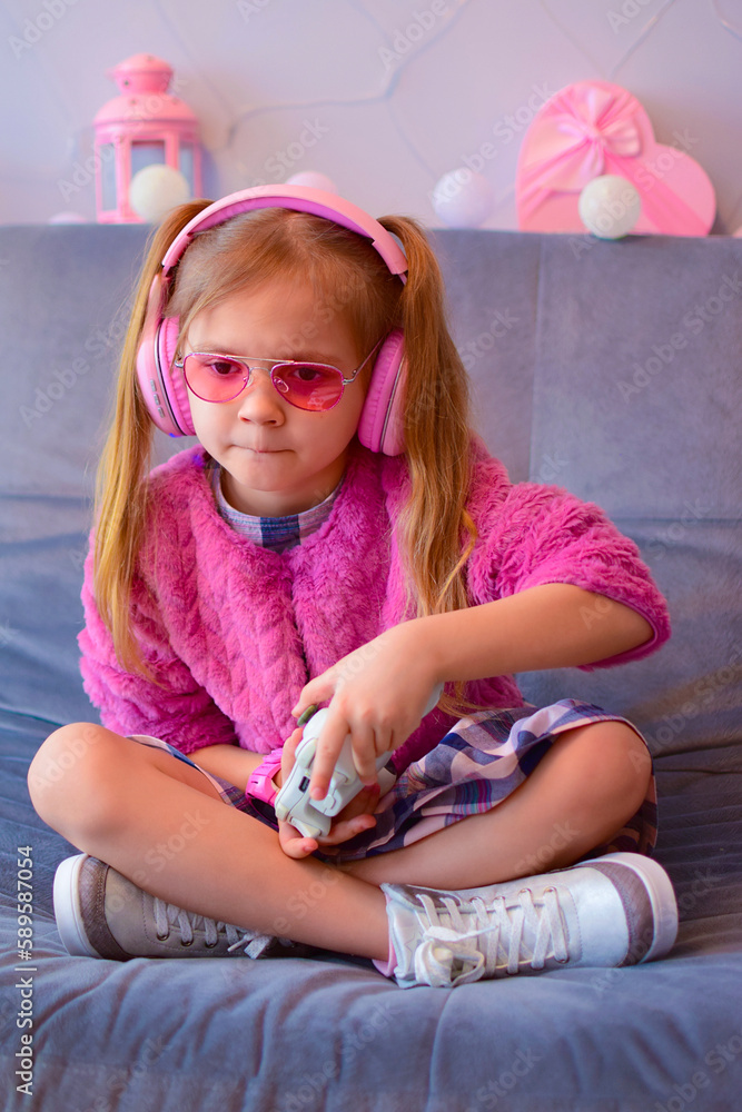 Child gamer. The unique child plays video games expressively. A ...