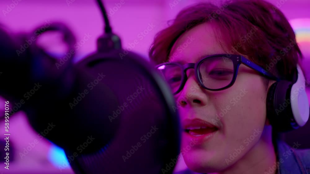 Close up portrait of asian young man singing with Headphones Record ...