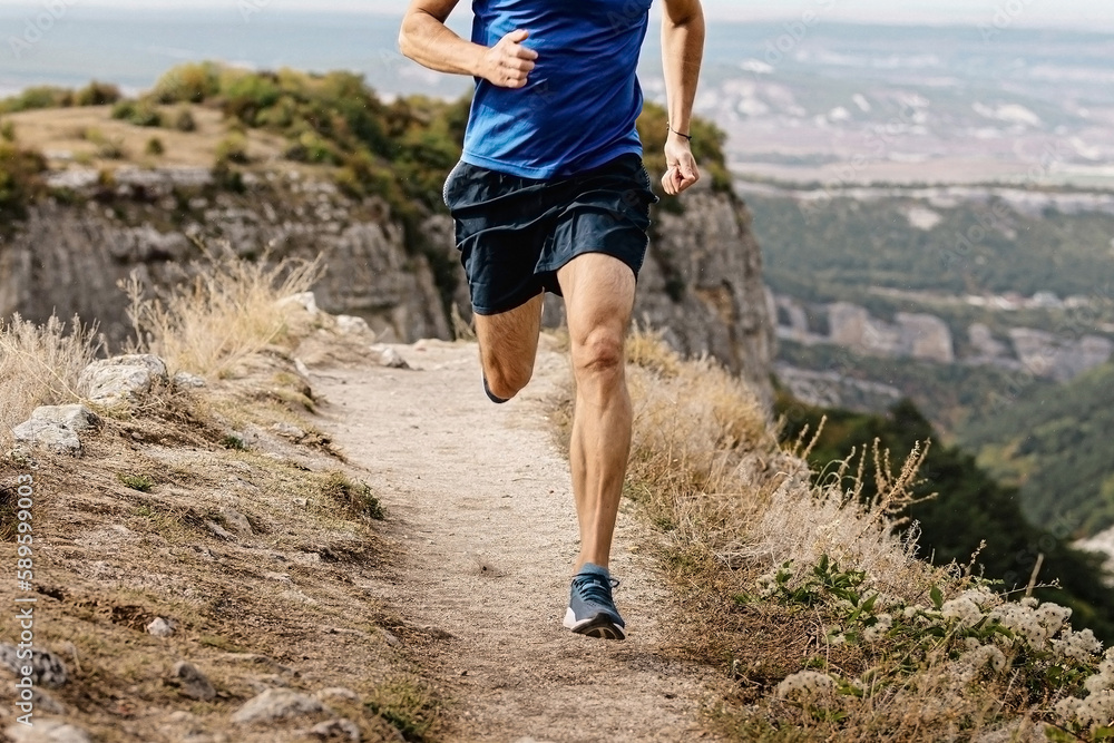 rangy male runner run on mountain trail, muscular legs man jogger ...