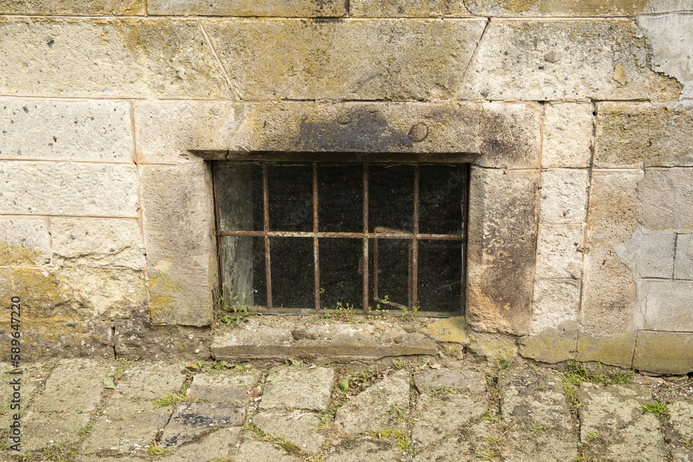 Barred basement window of an old building Stock Photo | Adobe Stock