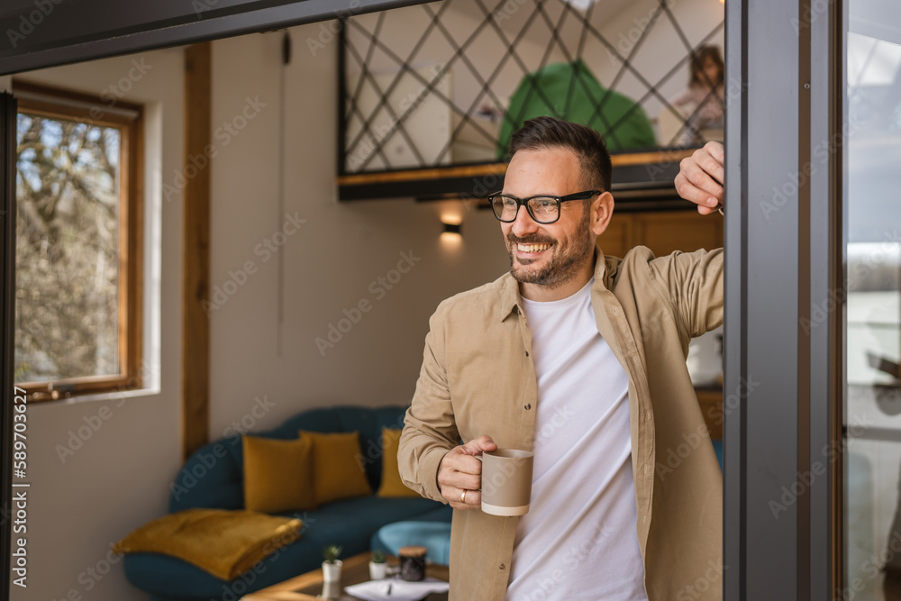One adult man stand in at door of tiny house happy smile hold cup Stock ...