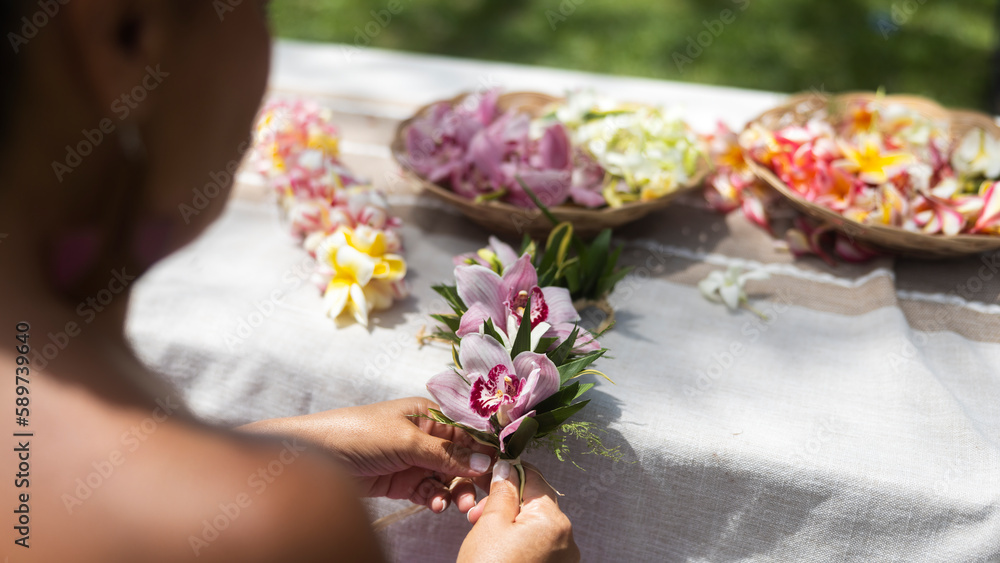 Woman making Hawaiian Lei and Hahu. Process of Handmade flower crown ...
