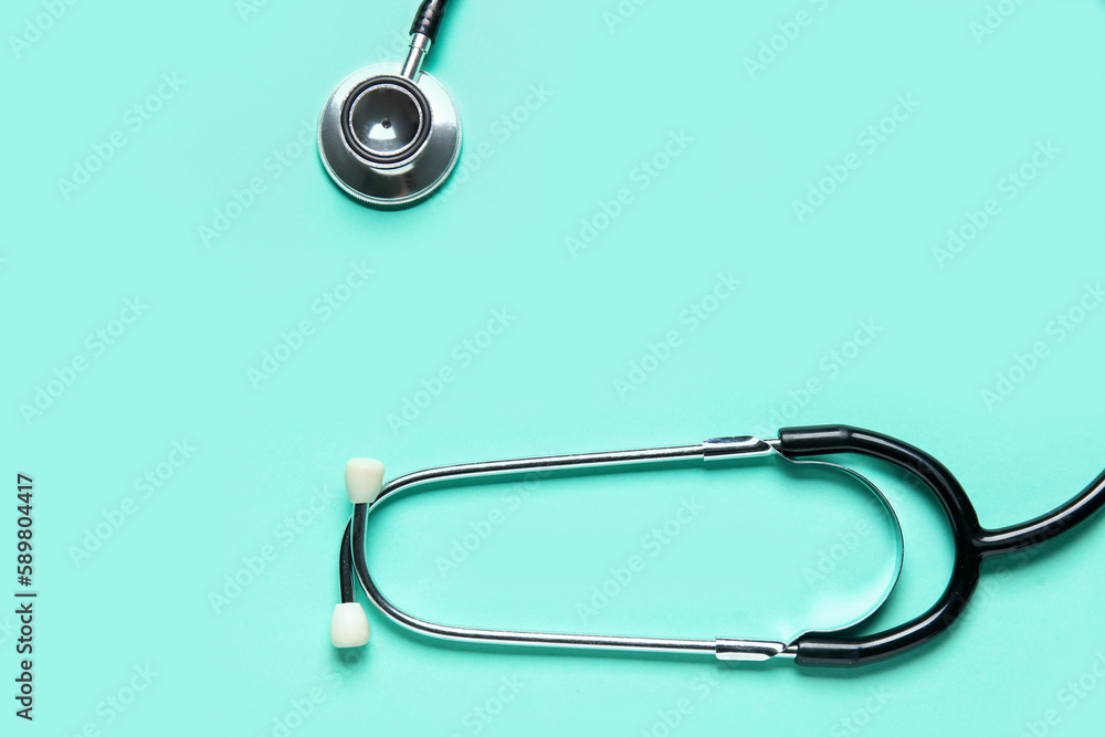 Modern stethoscope on turquoise background Stock Photo | Adobe Stock