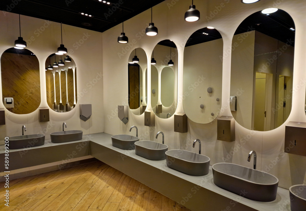 modern public toilet interior. empty public bathroom with sinks and ...