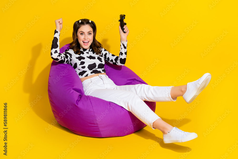 Full body photo of positive lady playing vide game raise fists up ...