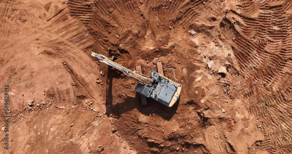 Aerial footage of Wheel Loader and a bagger working on a hill at a ...