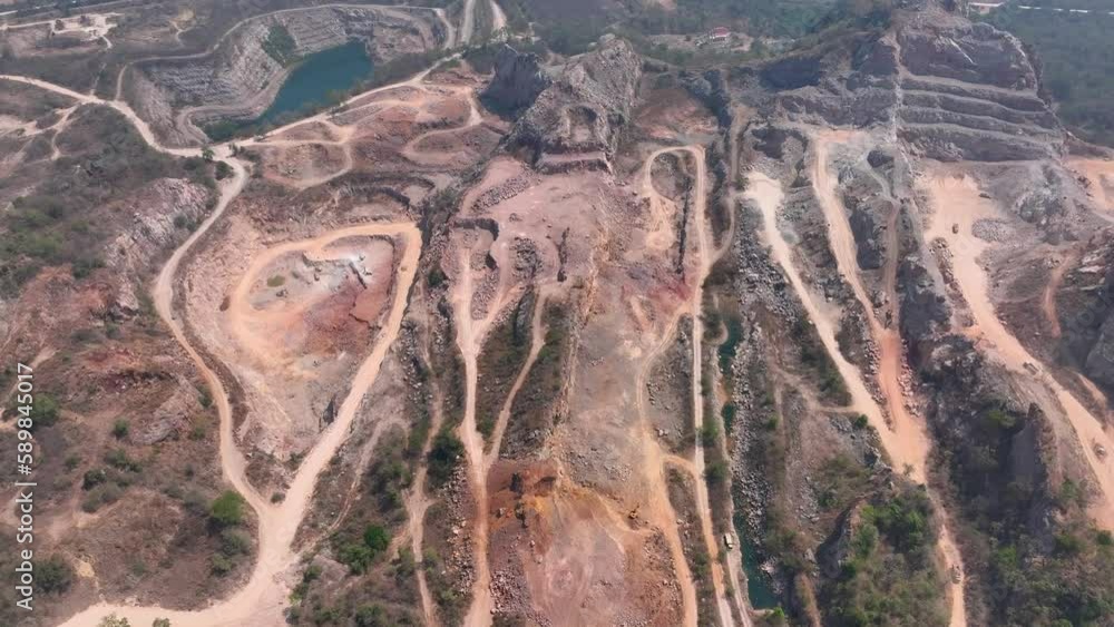 Aerial views of quarries show large-scale mining operations, with deep ...