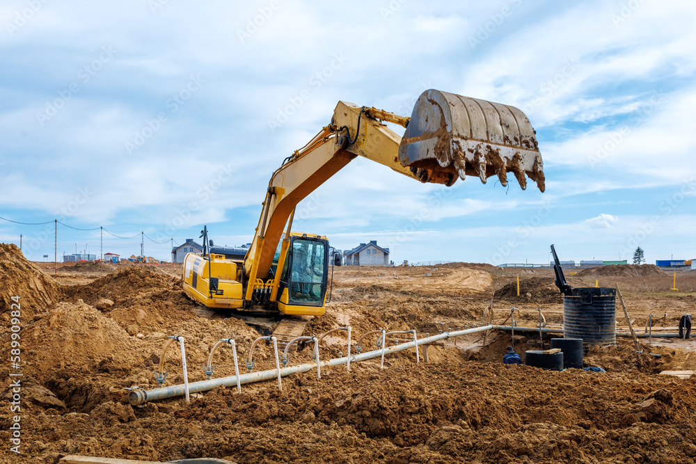 Excavator dig the trenches at a construction site. Trench for laying ...