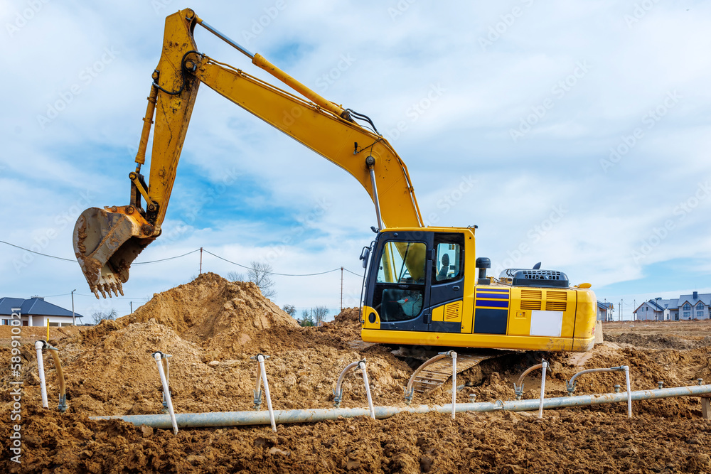 Excavator dig the trenches at a construction site. Trench for laying ...