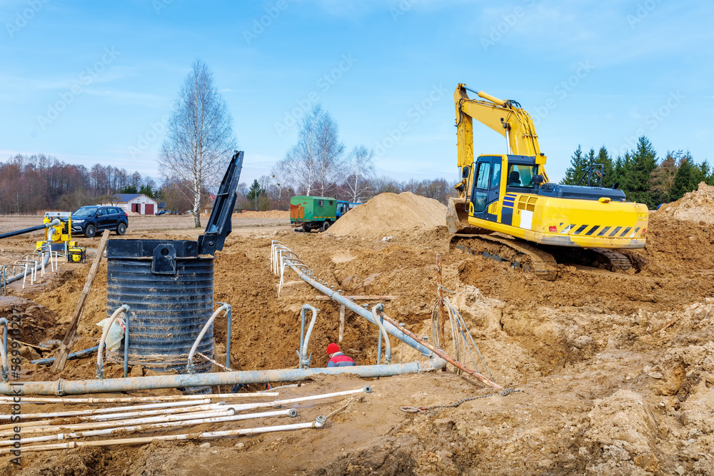 Excavator dig the trenches at a construction site. Trench for laying ...