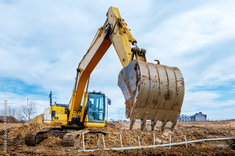 Excavator dig the trenches at a construction site. Trench for laying ...