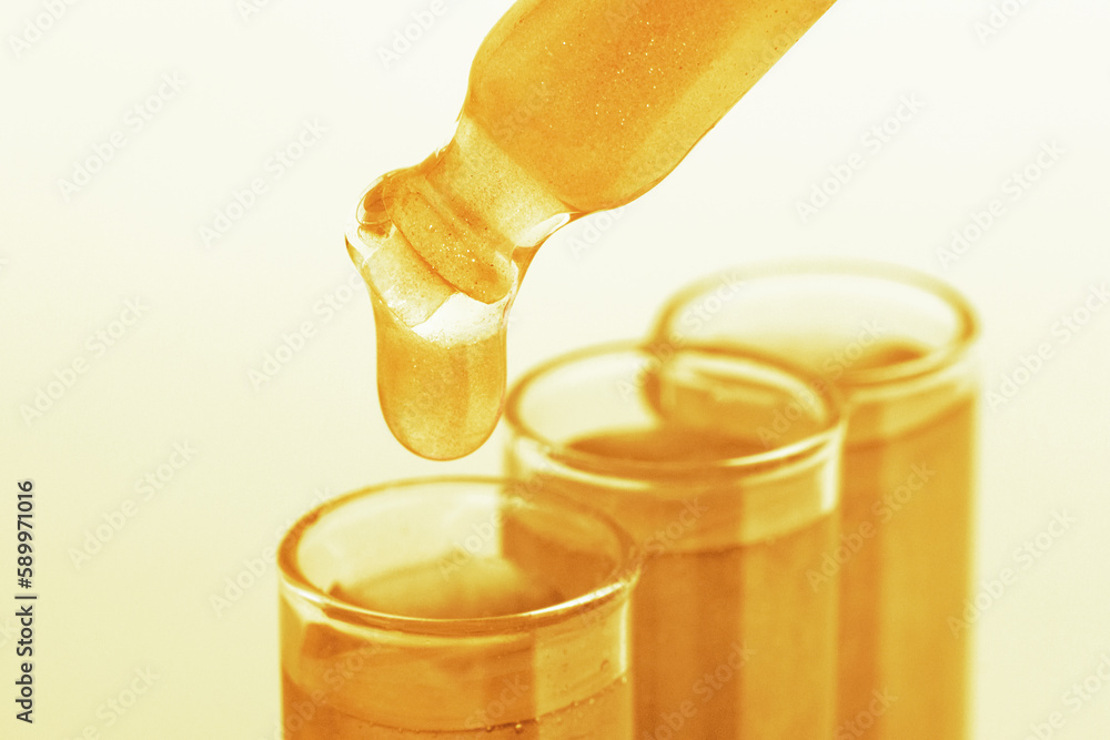 Test tube with flowing gold. Pipette with flowing gold. Glitter ...