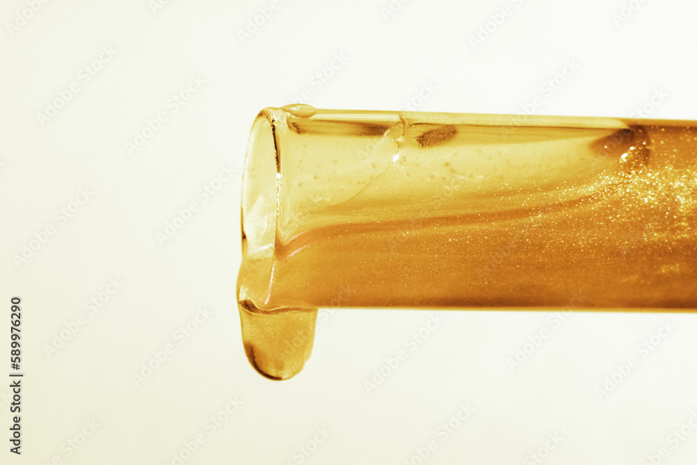 test tube with flowing gold. Glitter, varnish, liquid. Sequins ...
