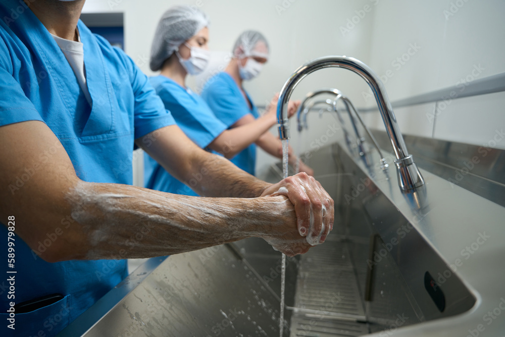 Team of surgeons thoroughly washes their hands before surgery Stock ...