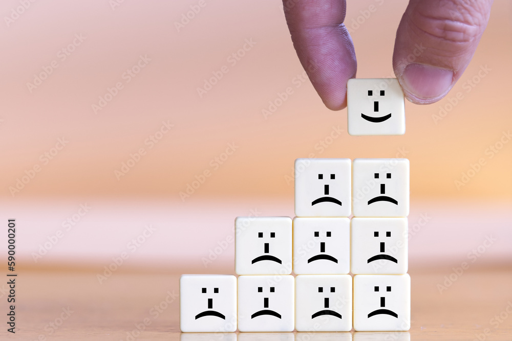 Stack of blocks with sad face icons. A single block with a happy face ...