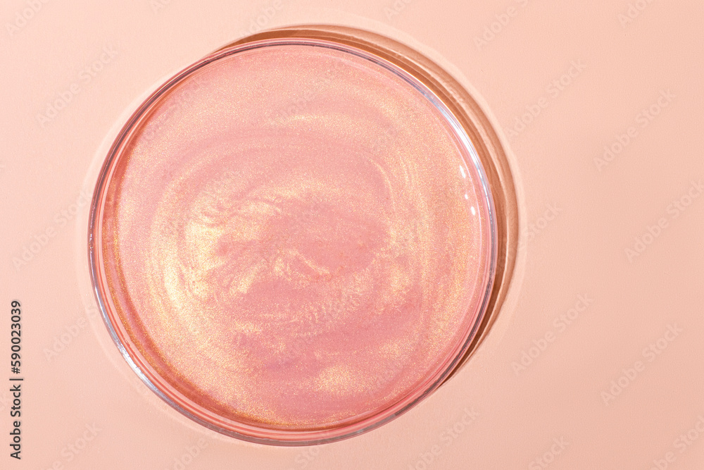 Liquid rose gold. Or a pink liquid with glitter. In a Petri dish ...