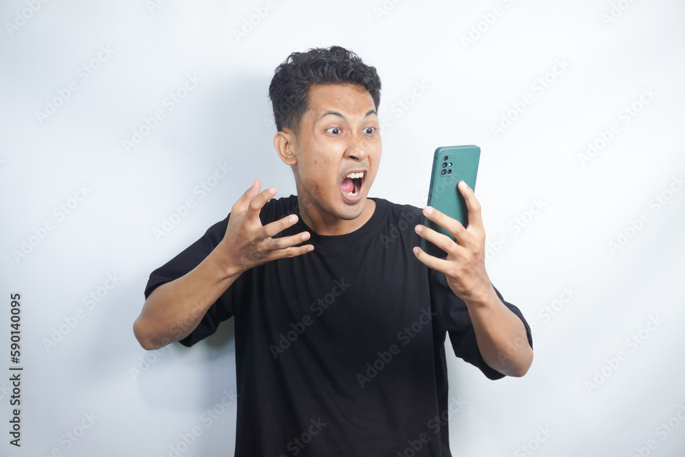 Smart Young Asian man is confused, angry and stresses when look ...