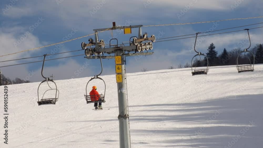Double chair chairlift (ski lift) tower with sheaves, ropes and ...