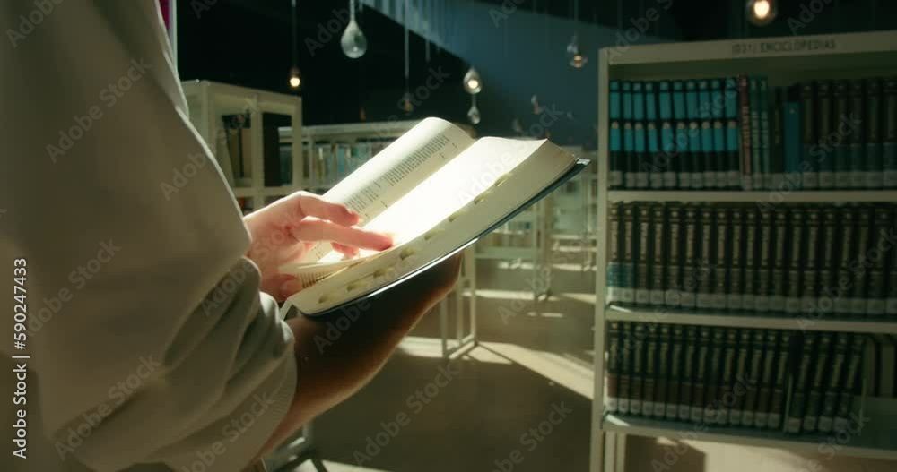 Student reading paper book at university. Female hand turnes pages of ...