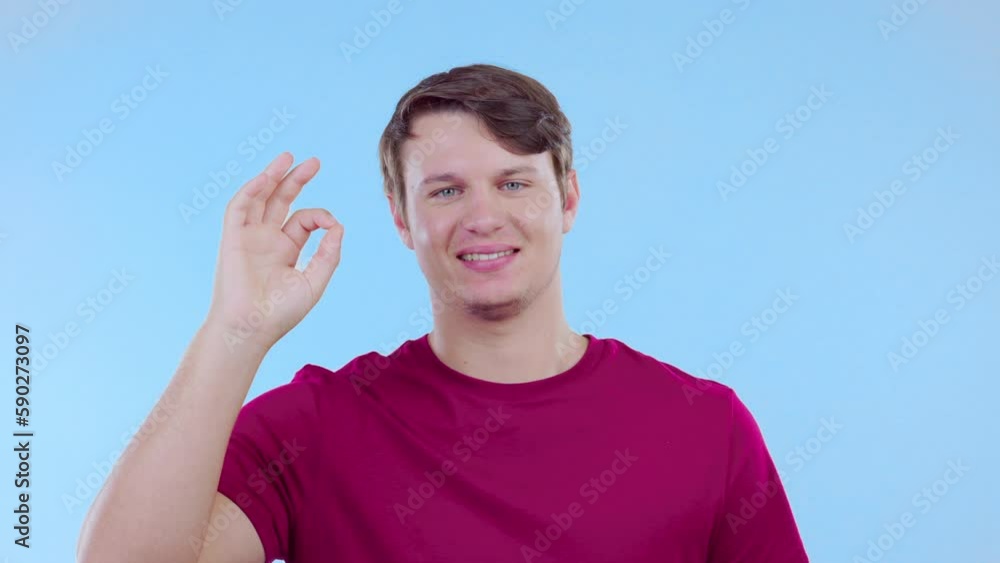 Happy man, ok hands and face in studio, blue background and good ...