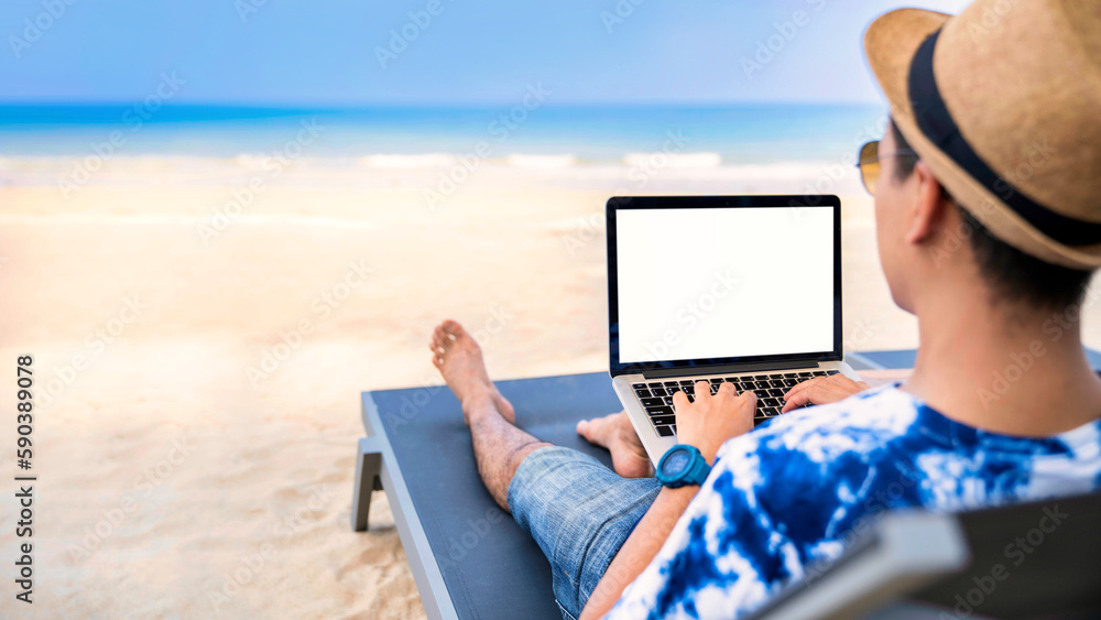 Young asian man working outdoor during his vacation time by laptop ...