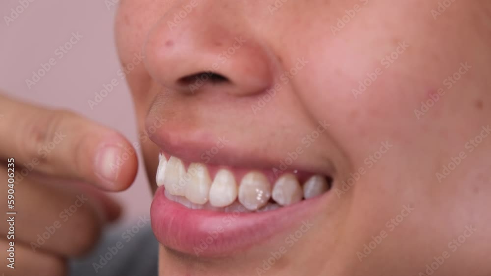 Close up side view of happy asian woman touching corner of mouth with ...