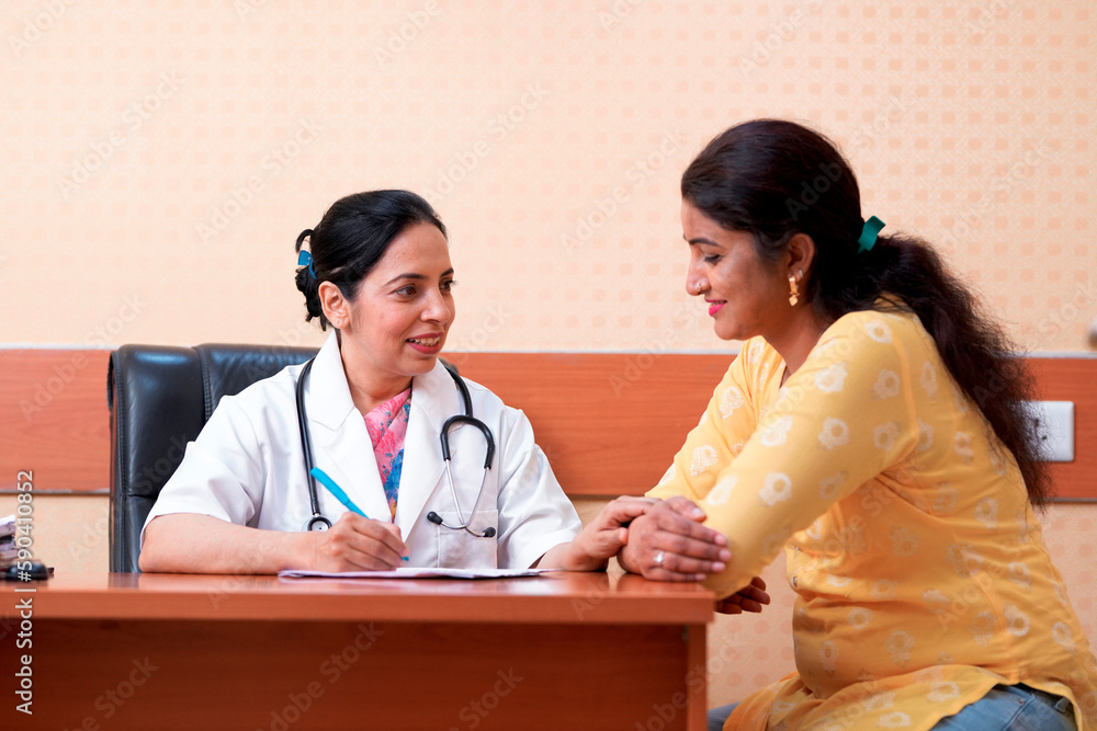 Indian female doctor writing prescription and discuss to woman. Stock ...