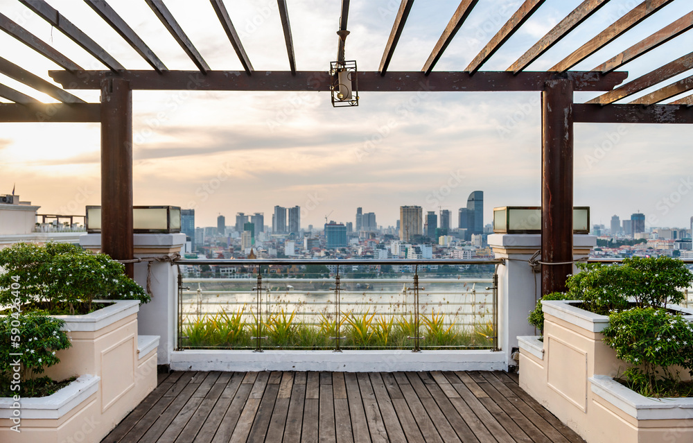 Rooftop view of Phnom Penh city skyline at sunset,looking across Tonle ...