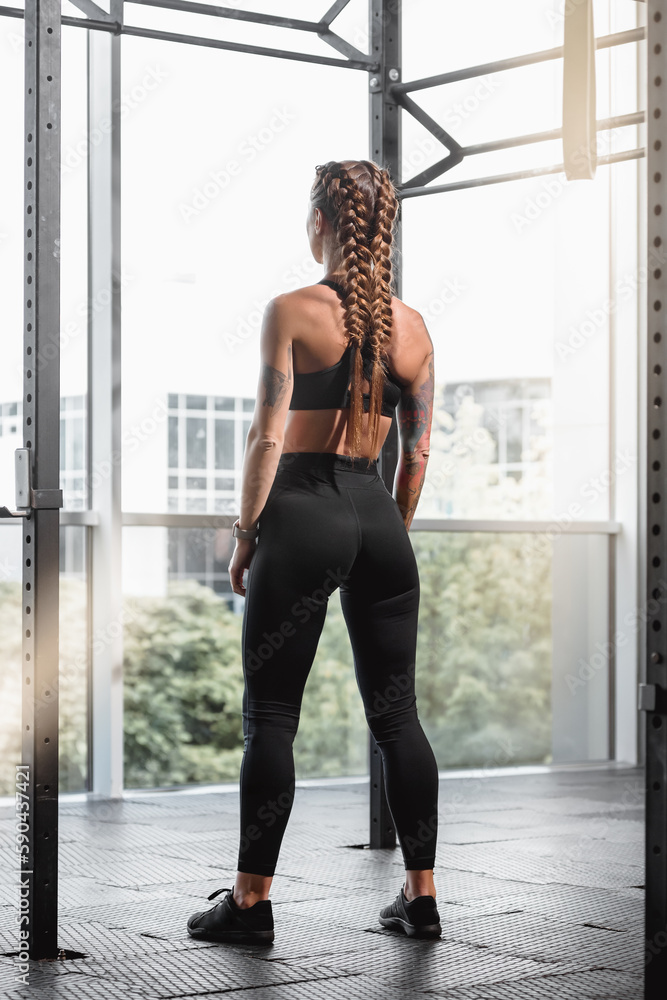 Rear view of athletic slim fit girl doing pull ups Stock Photo | Adobe ...