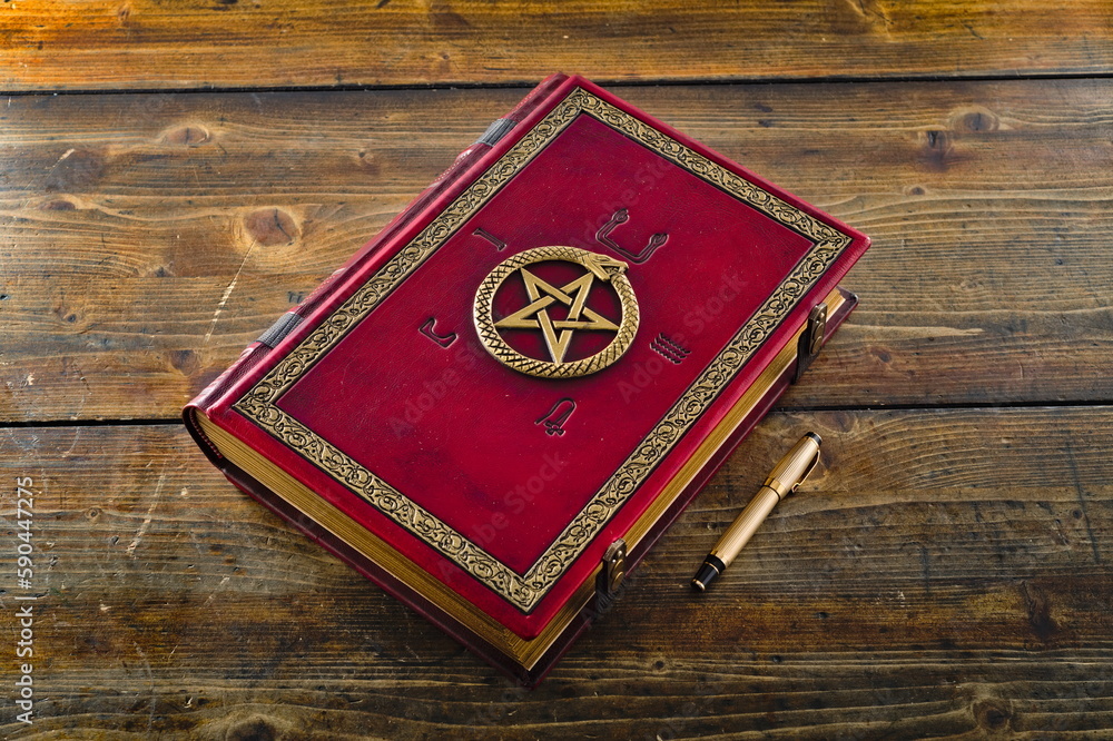 Red leather book with Ouroboros, pentagram and ancient Egyptian Symbols ...