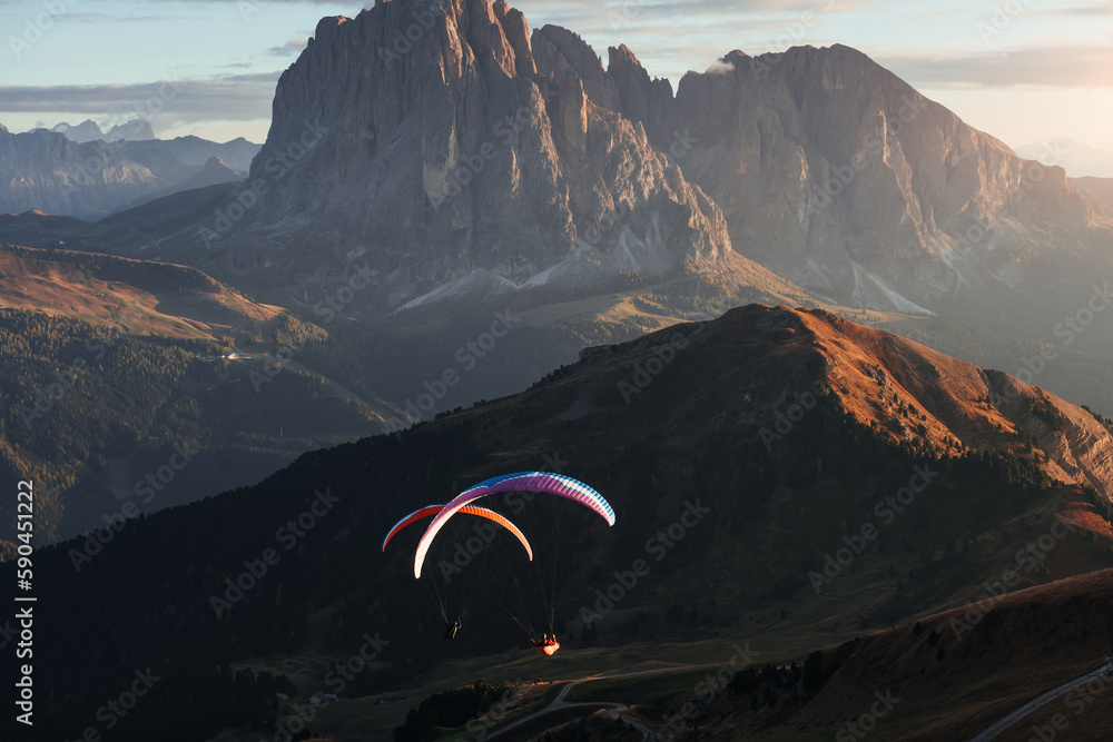 The Seceda dolomites and two paragliders on the sunset lights Stock ...