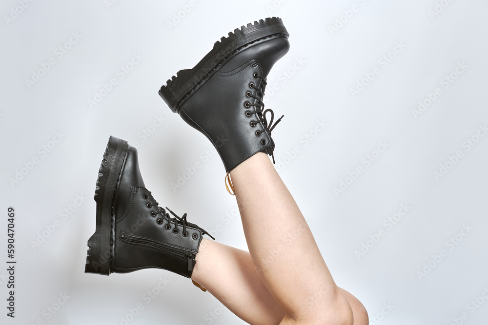 Woman legs in black combat boots on high heel platform with lug soles ...
