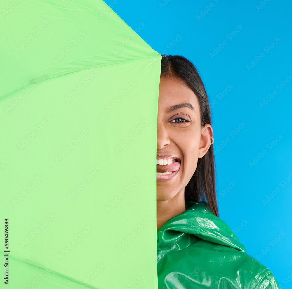 Umbrella, silly and woman portrait with tongue out in studio with ...