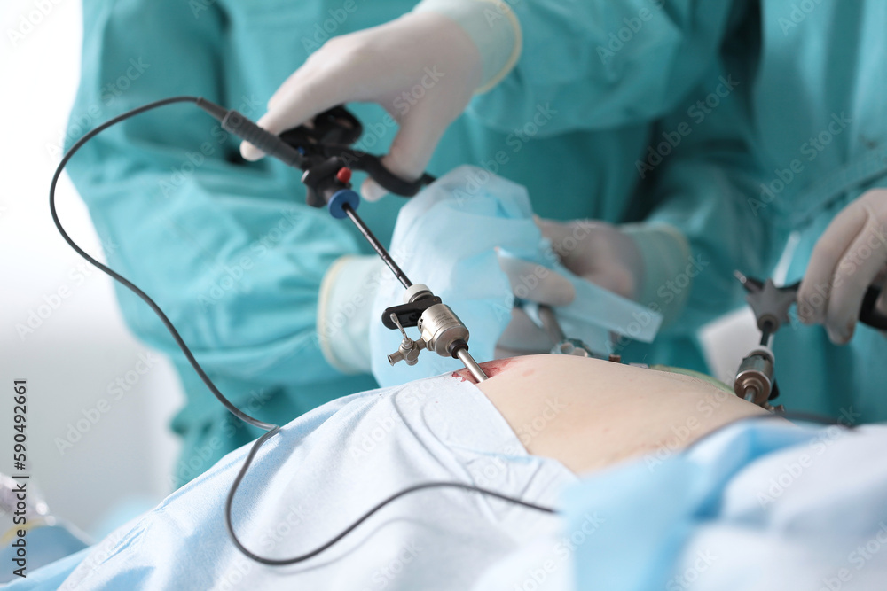 Laparoscopic instruments in the hands of a surgeon. Modern abdominal ...