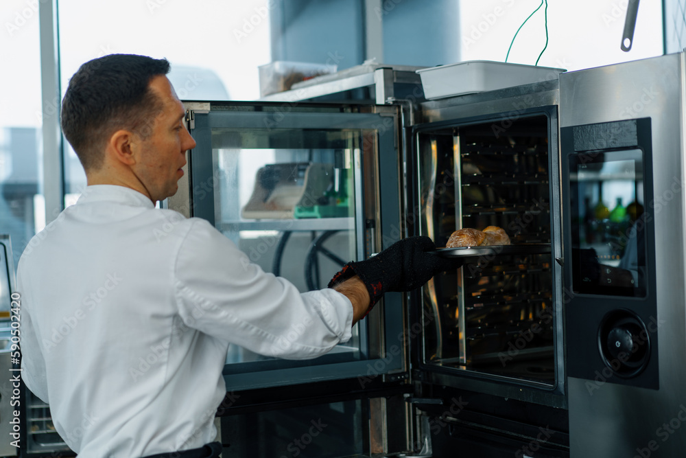 Professional modern kitchen in the restaurant the chef takes out the ...