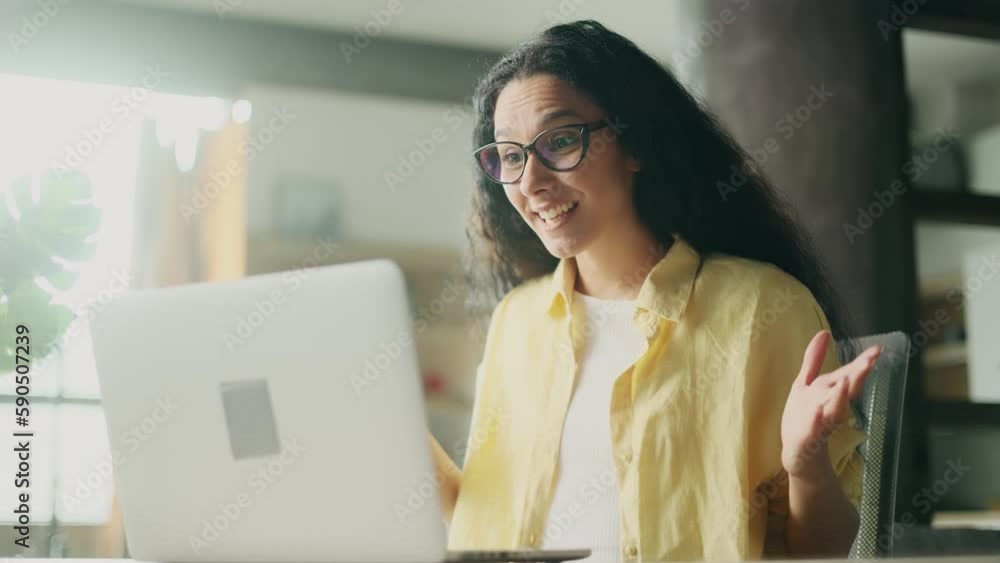 Portrait of beautiful hispanic woman with glasses having video call ...