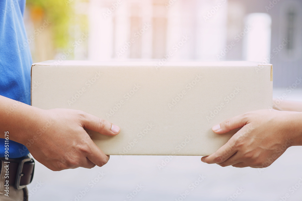 parcel delivery man of a package through a service. and close up hand ...