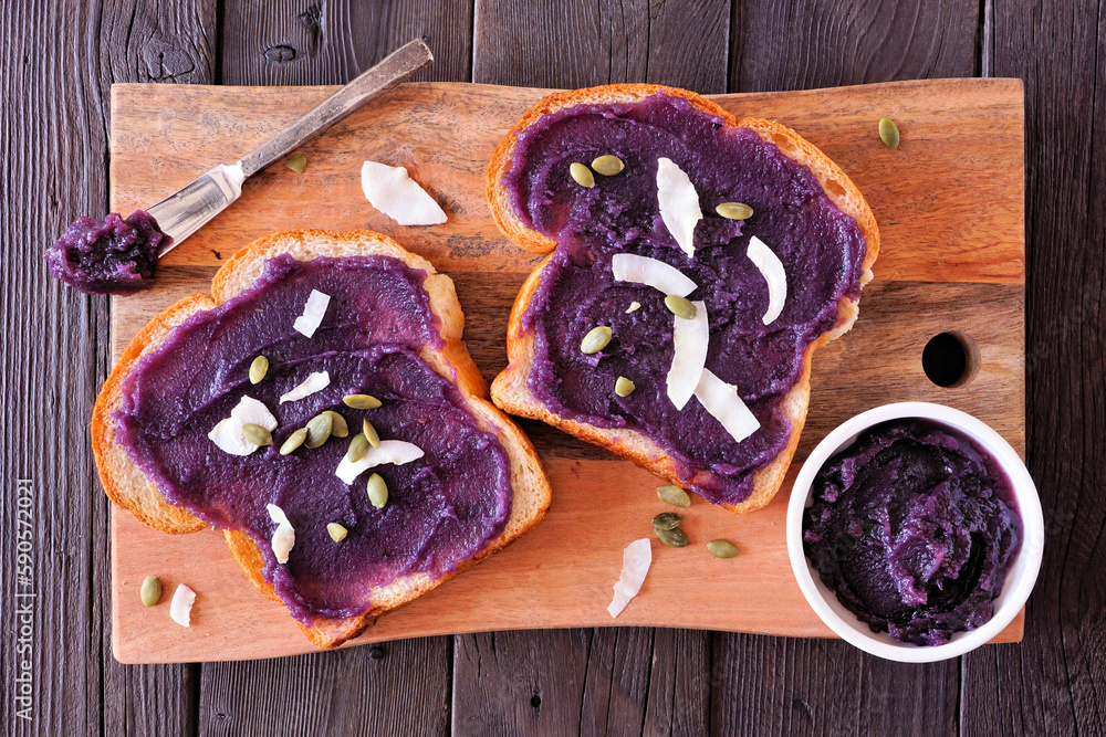 Toast with ube halaya jam, coconut and pumpkin seeds. Top down view ...